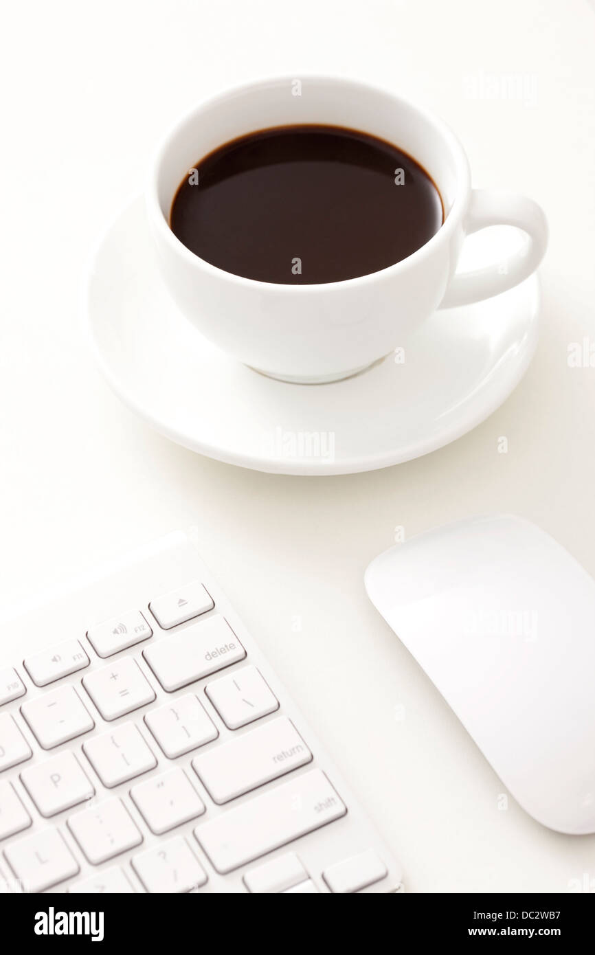 Coffee and computer on office desk Stock Photo - Alamy