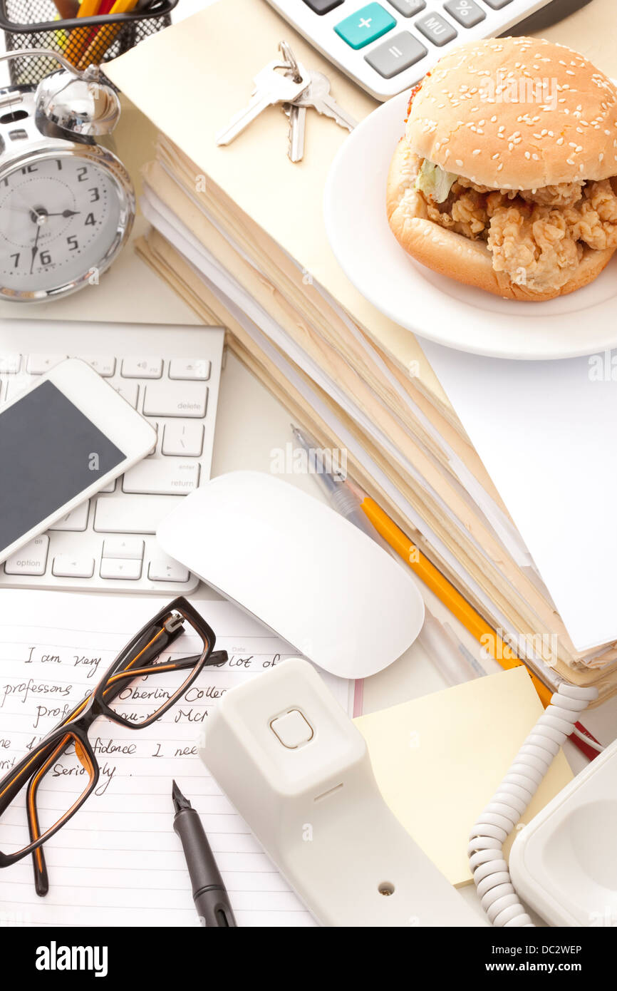 Fast food and other office items on desk Stock Photo - Alamy