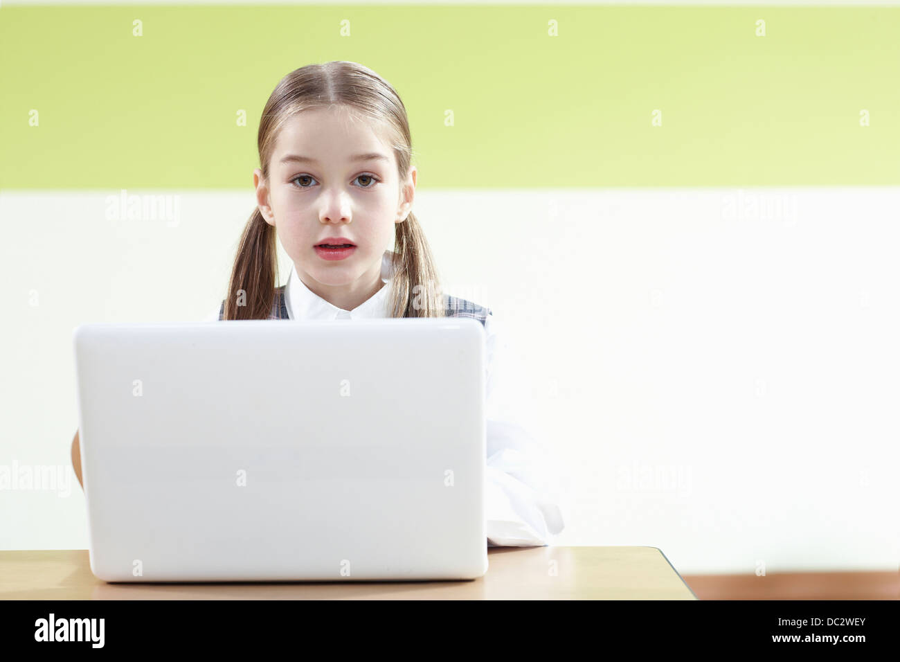 a girl using a laptop in a classroom Stock Photo - Alamy