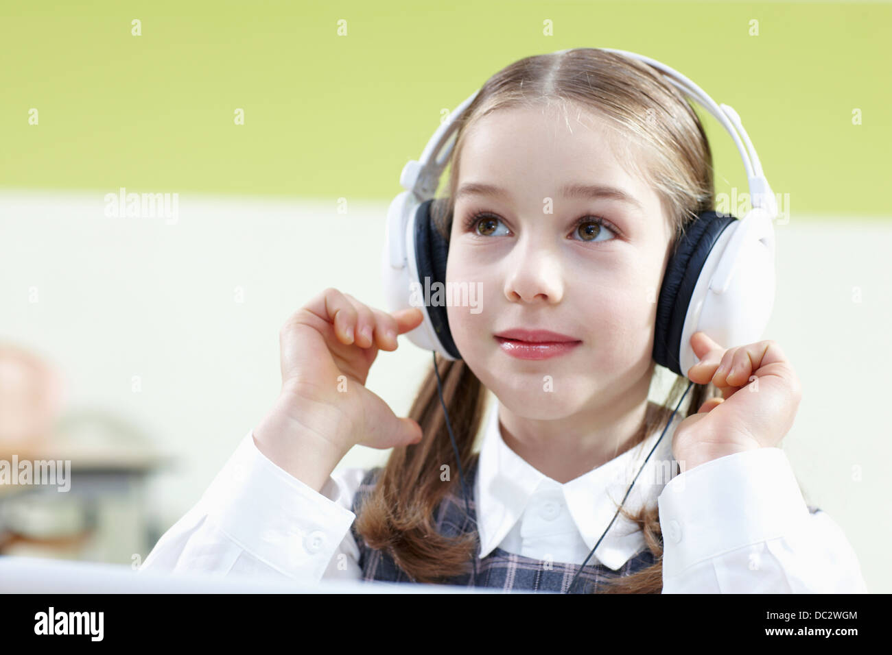 a girl wearing a headphone in a classroom Stock Photo - Alamy