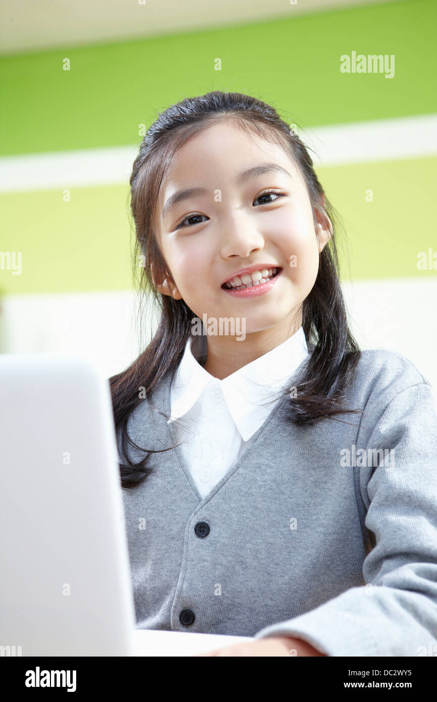 a girl using a laptop in a classroom Stock Photo - Alamy