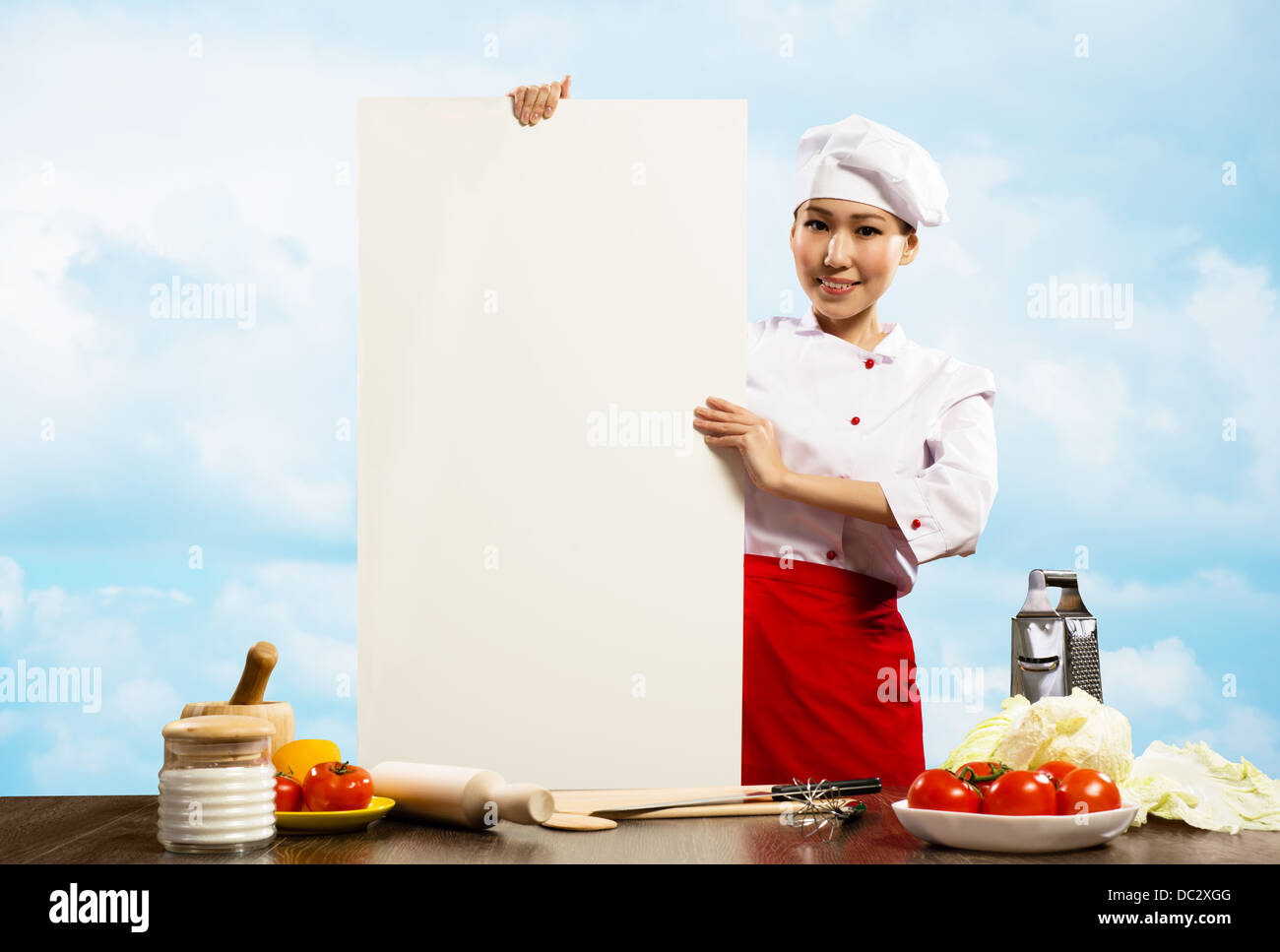 female chef holding a poster for text Stock Photo - Alamy