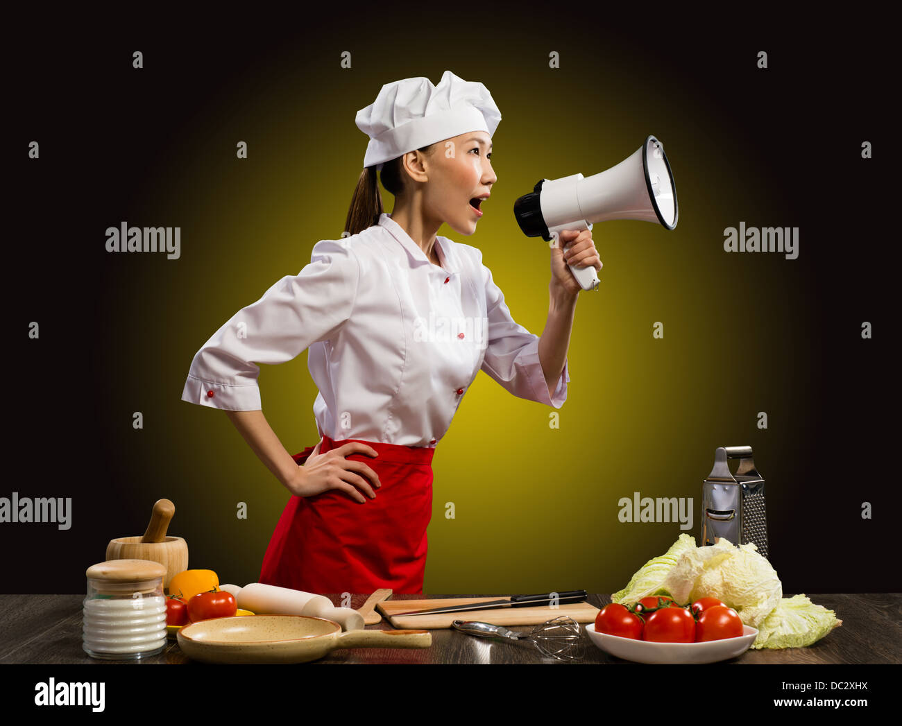 Asian female chef shouting into a megaphone Stock Photo - Alamy