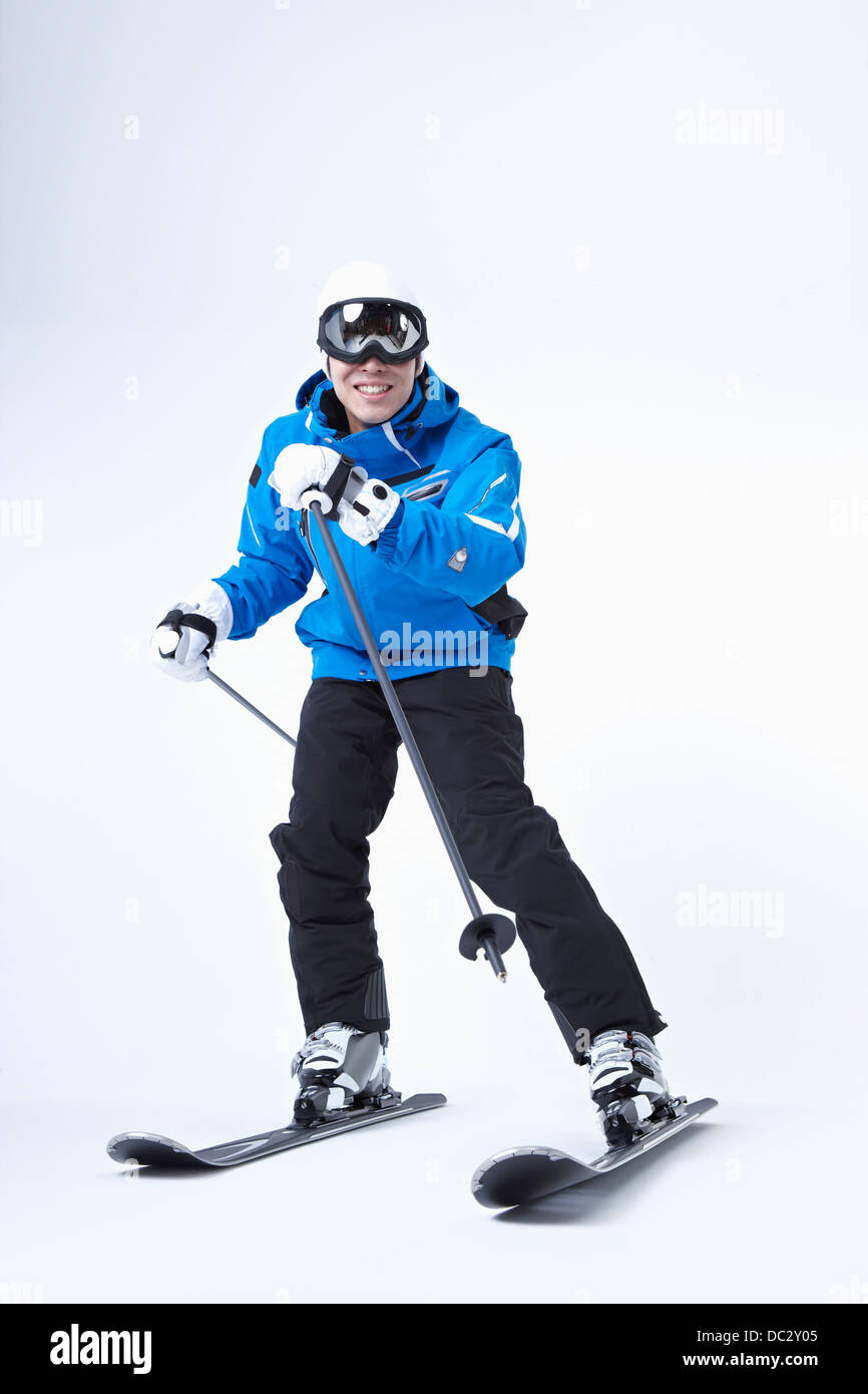 a man in ski outfit posing in white background Stock Photo - Alamy