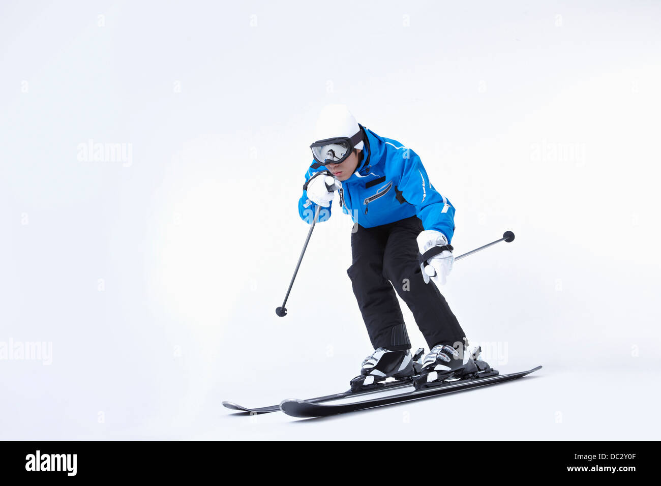 a man in ski outfit posing in white background Stock Photo - Alamy