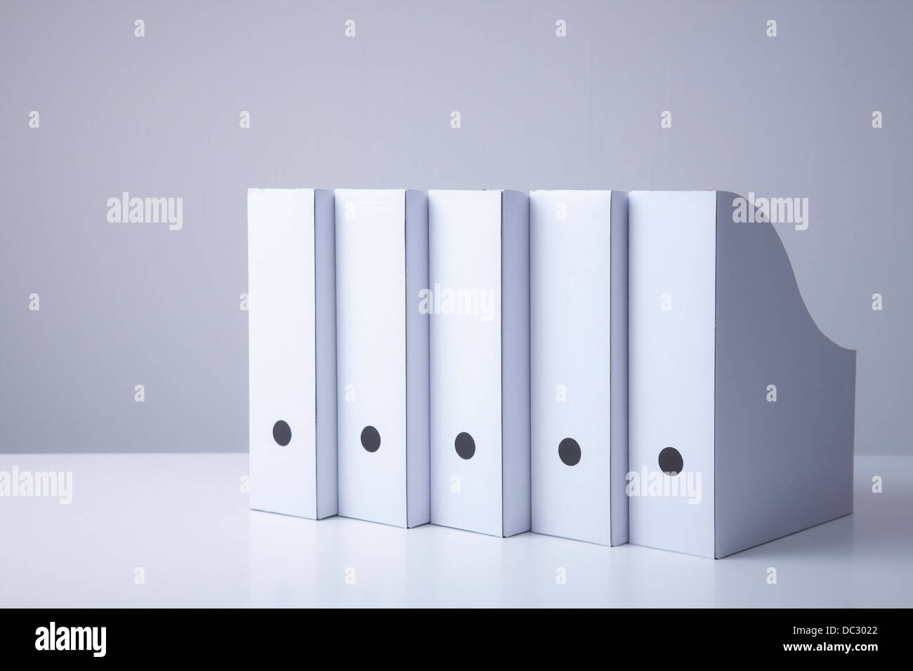 white magazine files in a line Stock Photo - Alamy
