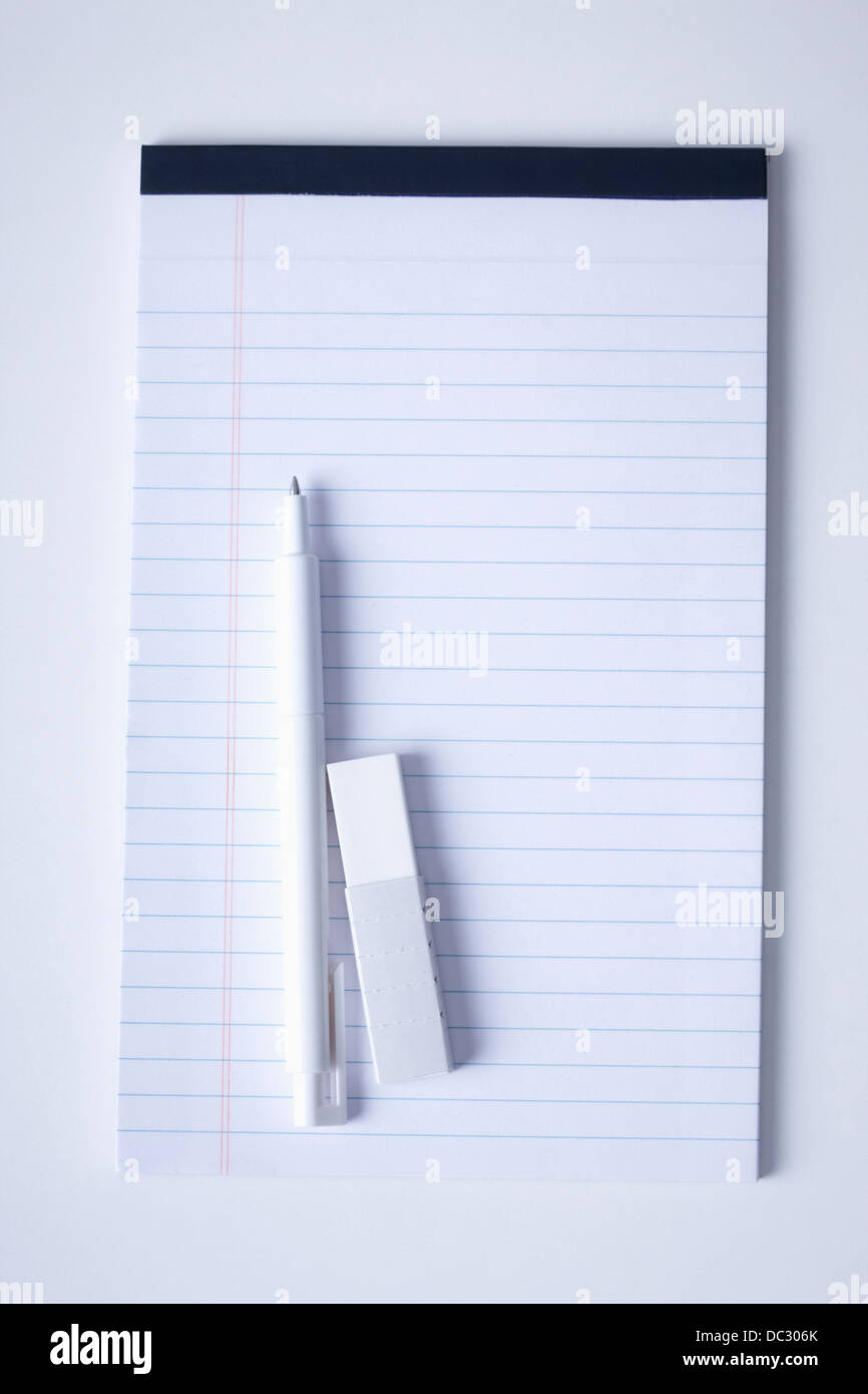 pen and eraser on white notepad Stock Photo - Alamy