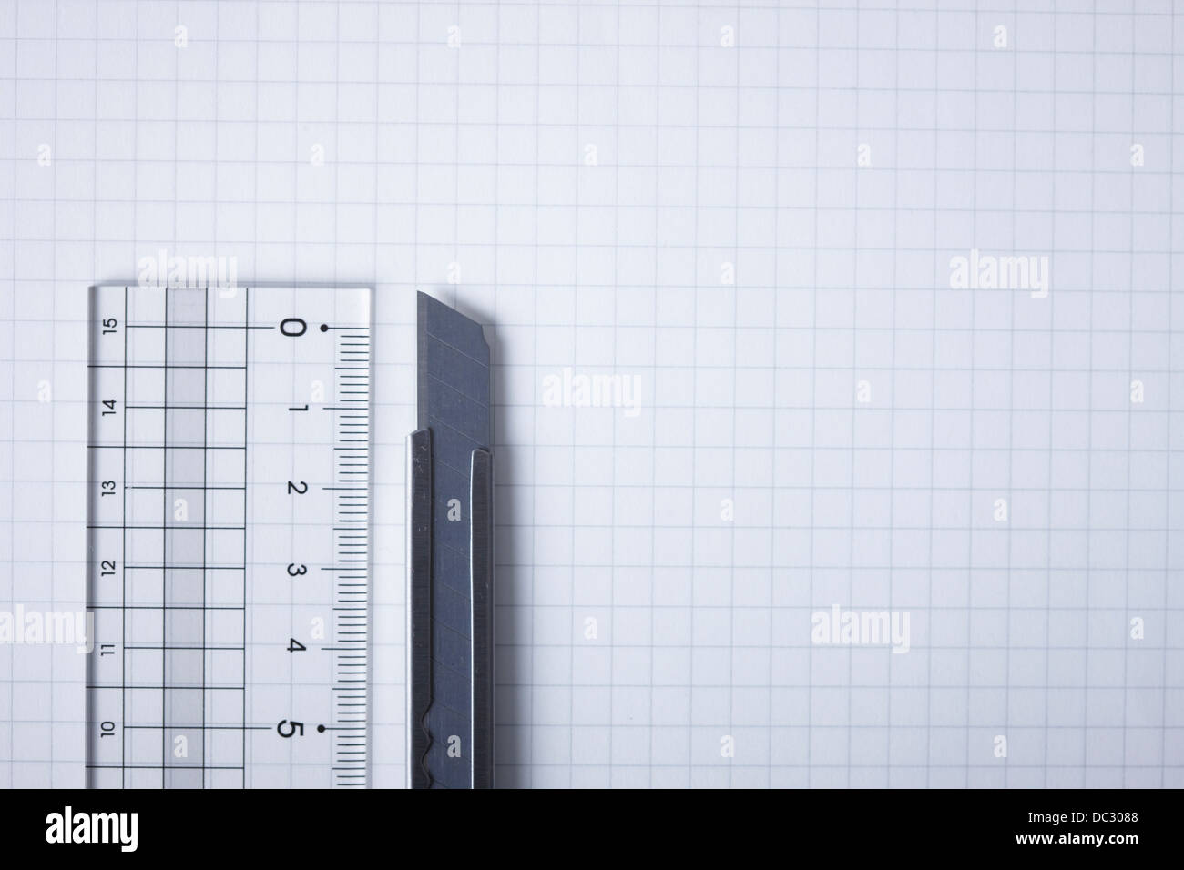 ruler and knife on white notepad Stock Photo - Alamy