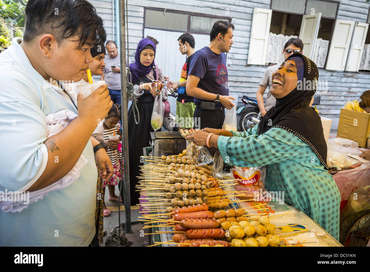 Bangkok, Thailand. 8th Aug, 2013. A food vendor sells grilled halal ...
