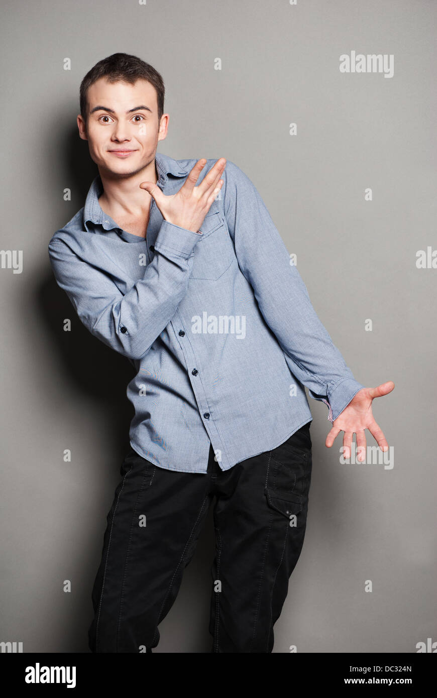 Happy smiling young man presenting and showing your text or product ...