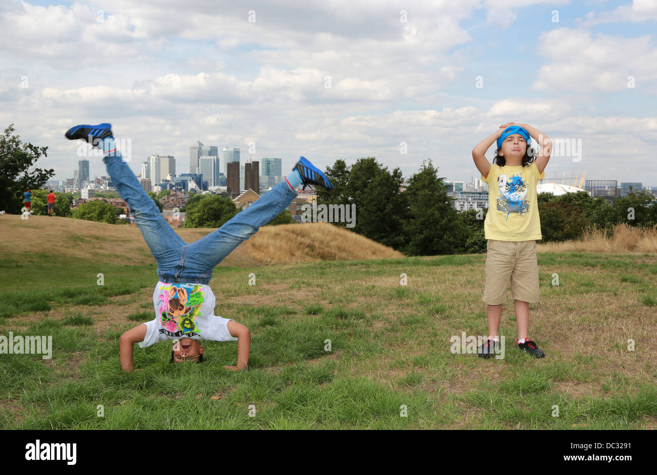 2 brothers doing handstands in the park Stock Photo - Alamy