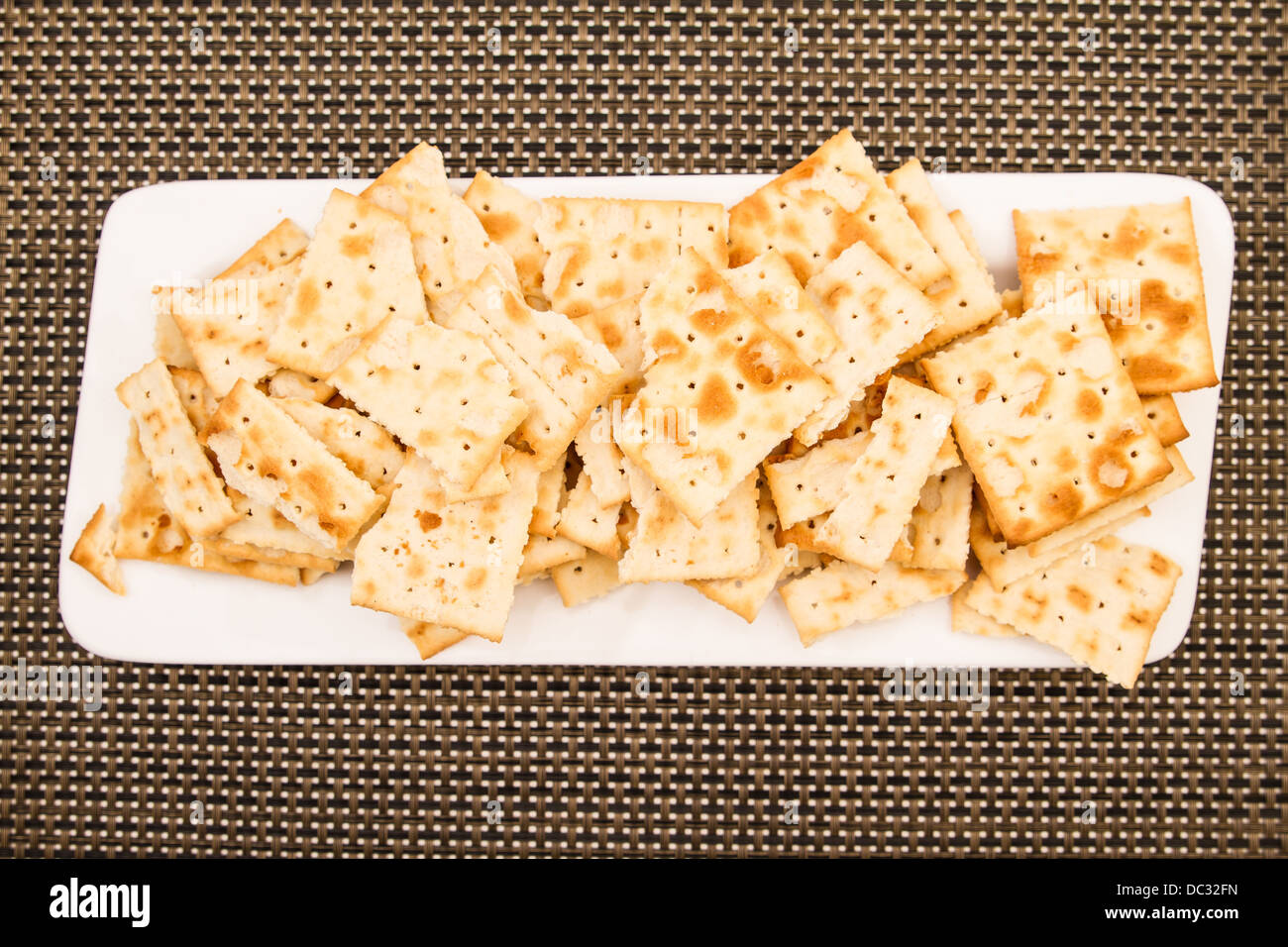 Lots of salted crackers, ones broken Stock Photo - Alamy