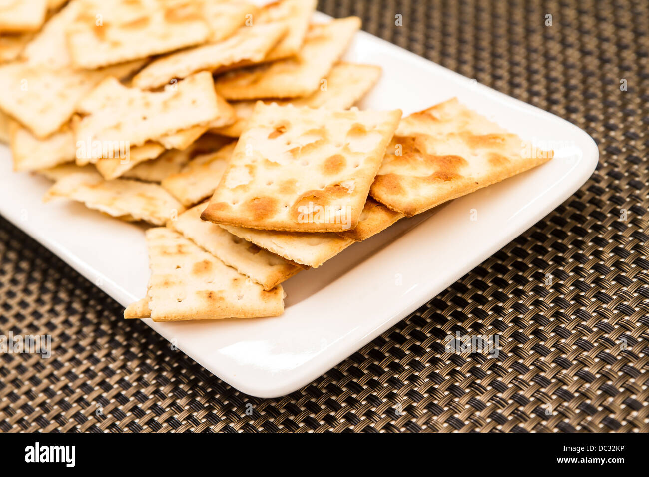 Lots of salted crackers, ones broken Stock Photo - Alamy