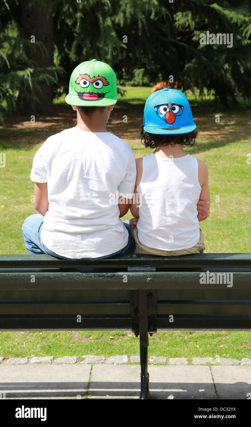Kid's sitting on park bench Stock Photo - Alamy