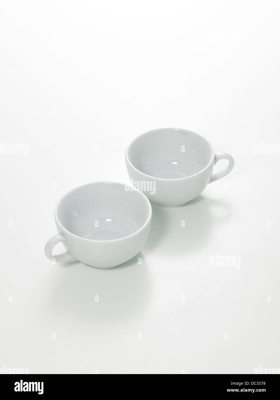 Two cups on white background Stock Photo - Alamy