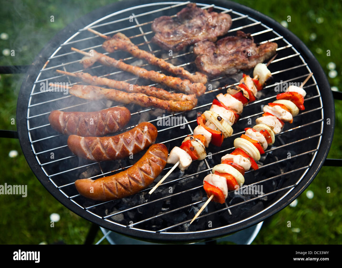 Cooking on the barbecue grill Stock Photo - Alamy