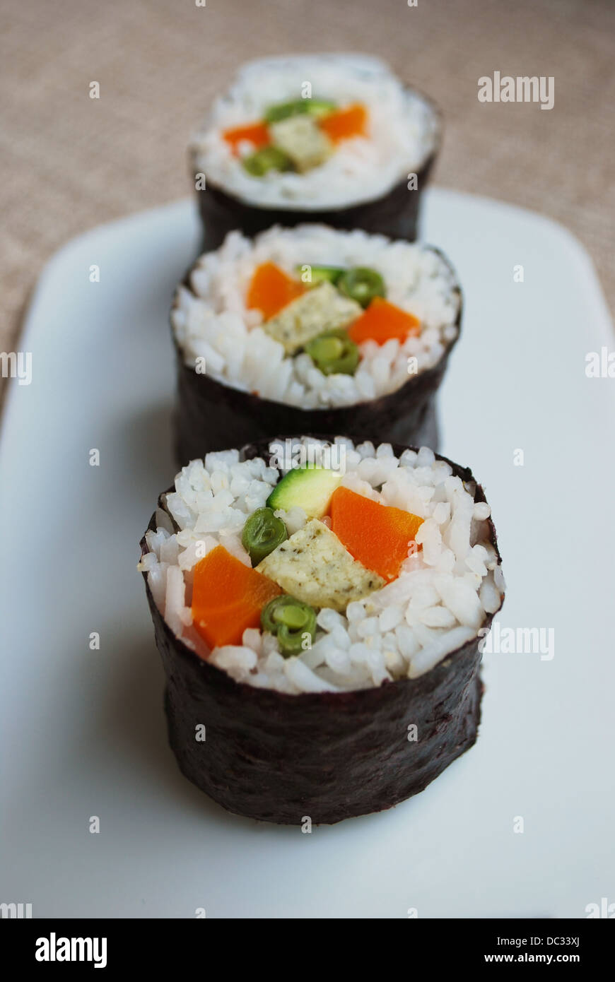 Vegetarian maki sushi rolls with rice, carrots, zucchini, green beans ...