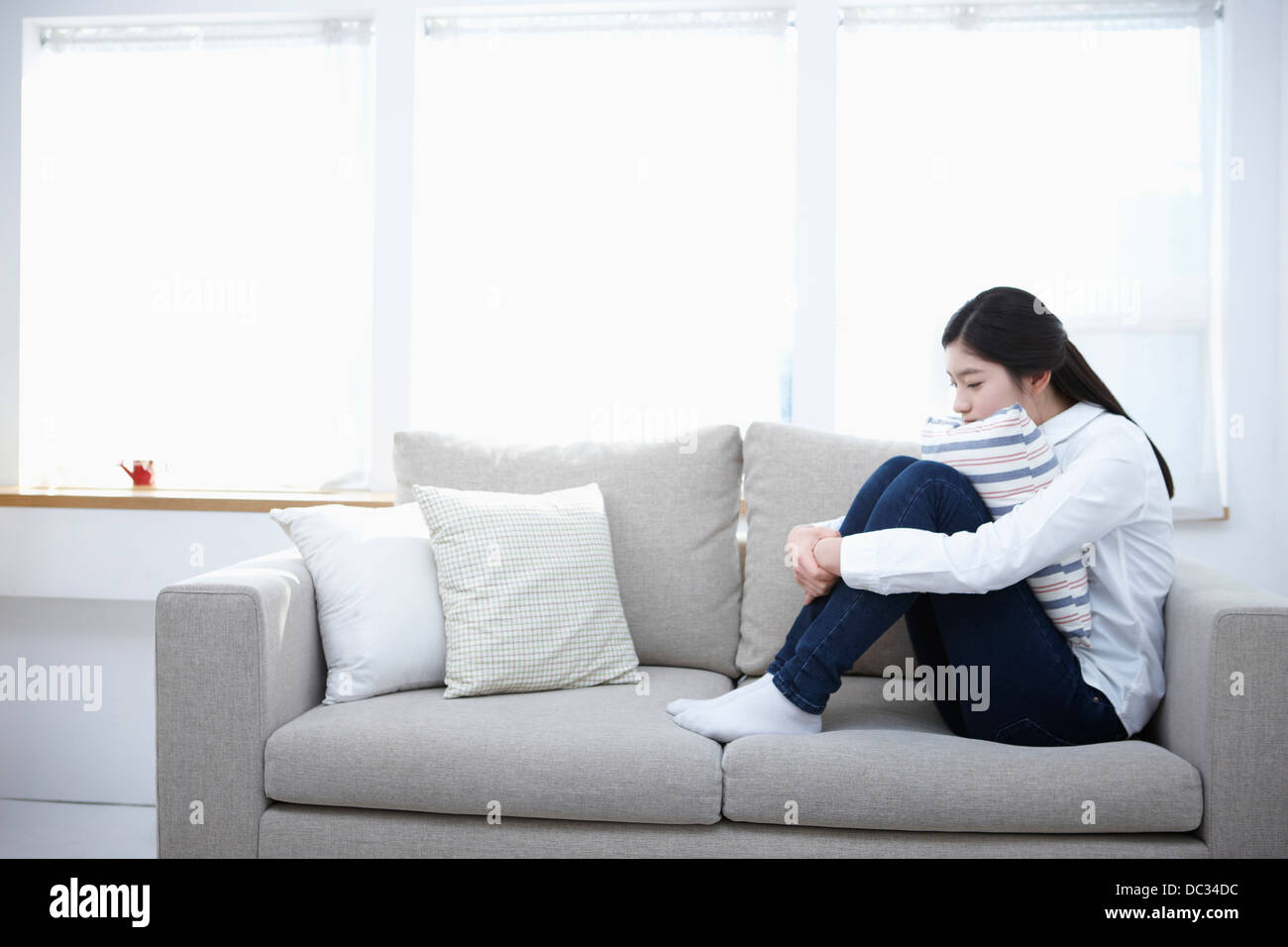 student sitting on a couch Stock Photo - Alamy
