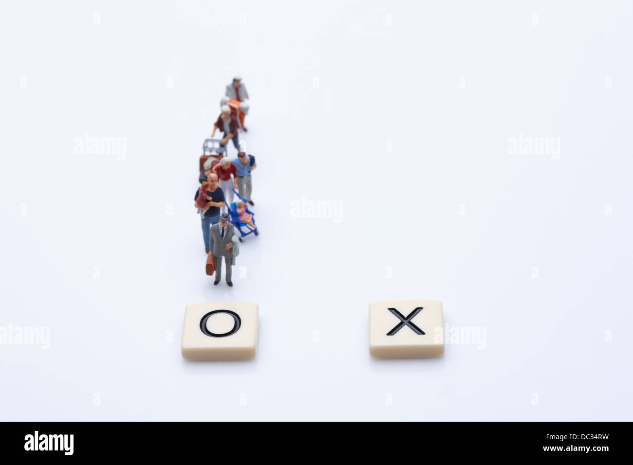 toy people lined up on correct button Stock Photo - Alamy