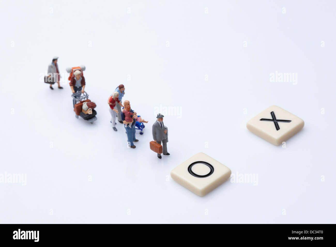 toy people lined up on correct button Stock Photo - Alamy