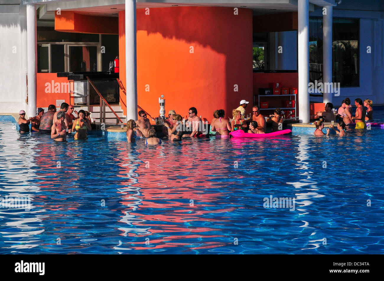Holidaymakers congregate around a bar in a swimming pool at a Mexican ...