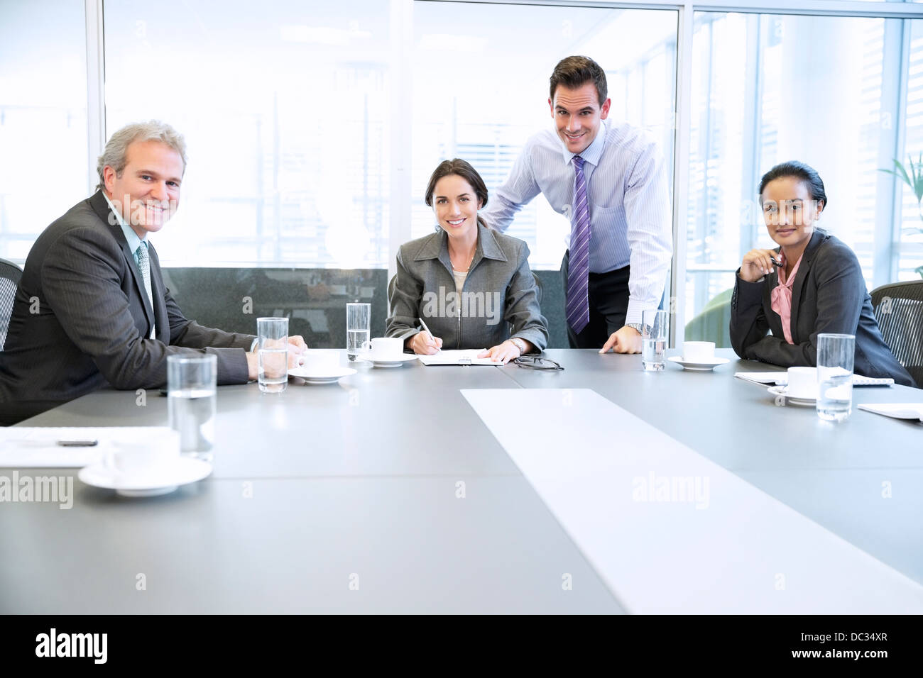 Portrait of smiling business people meeting in conference room Stock ...