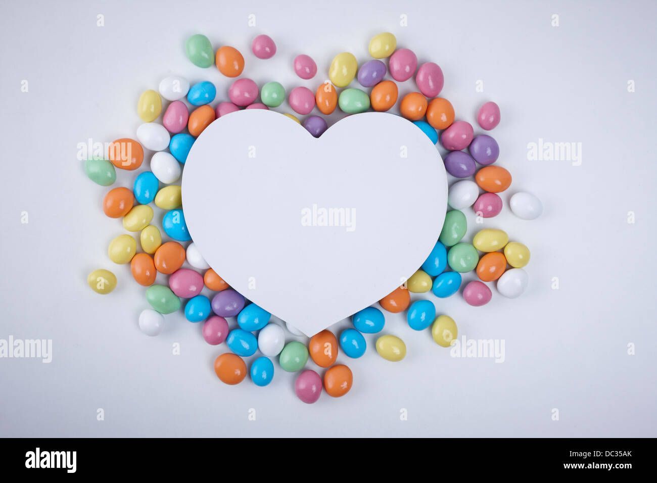 candies around heart shape design Stock Photo - Alamy