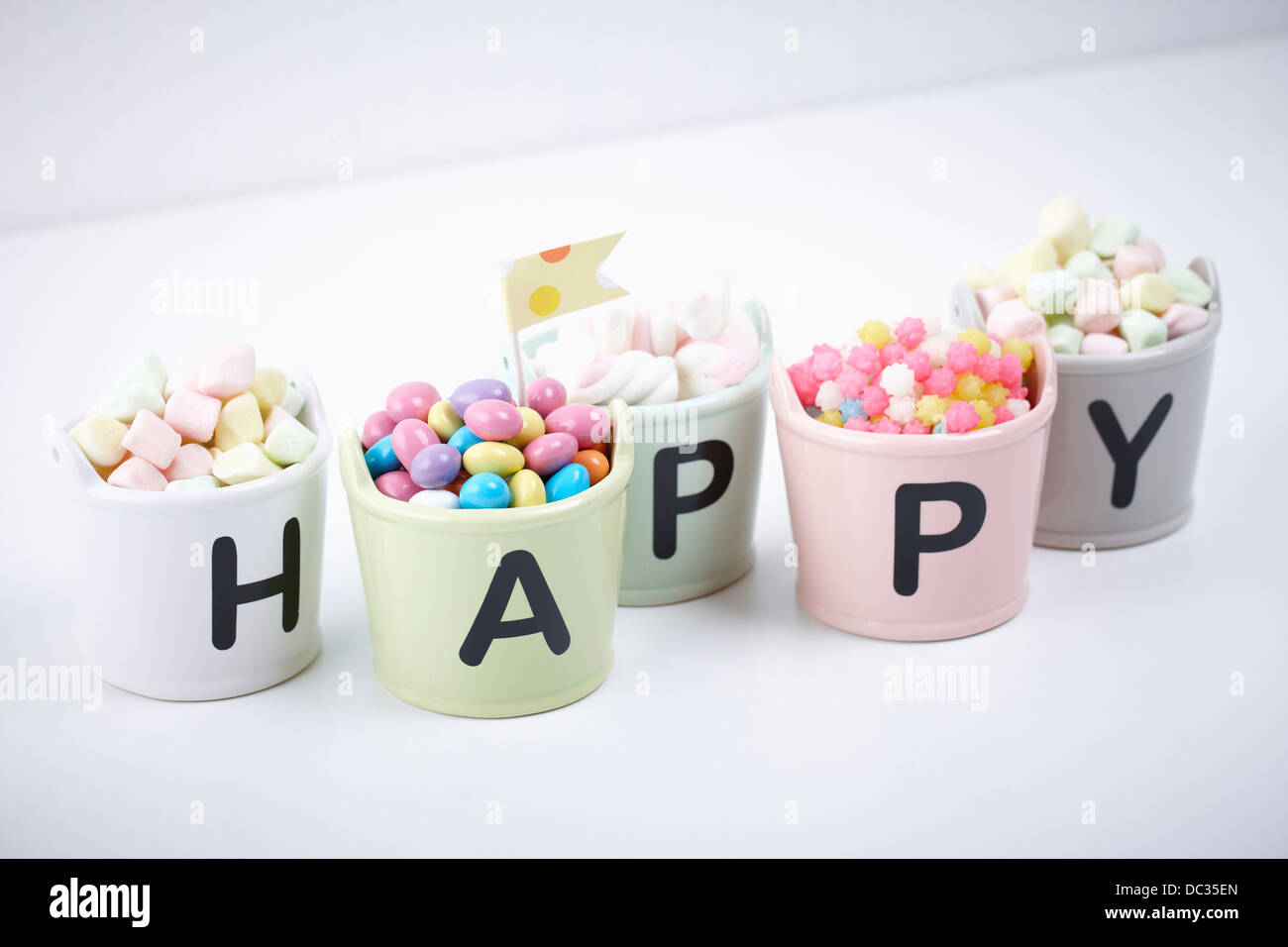candies in small candy basket with a word happy Stock Photo - Alamy