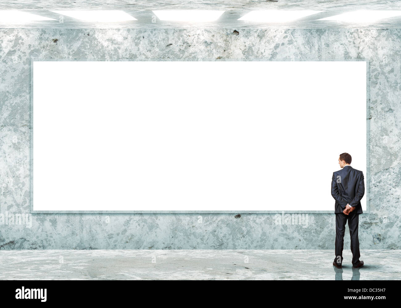 Business person standing near a blank billboard Stock Photo - Alamy