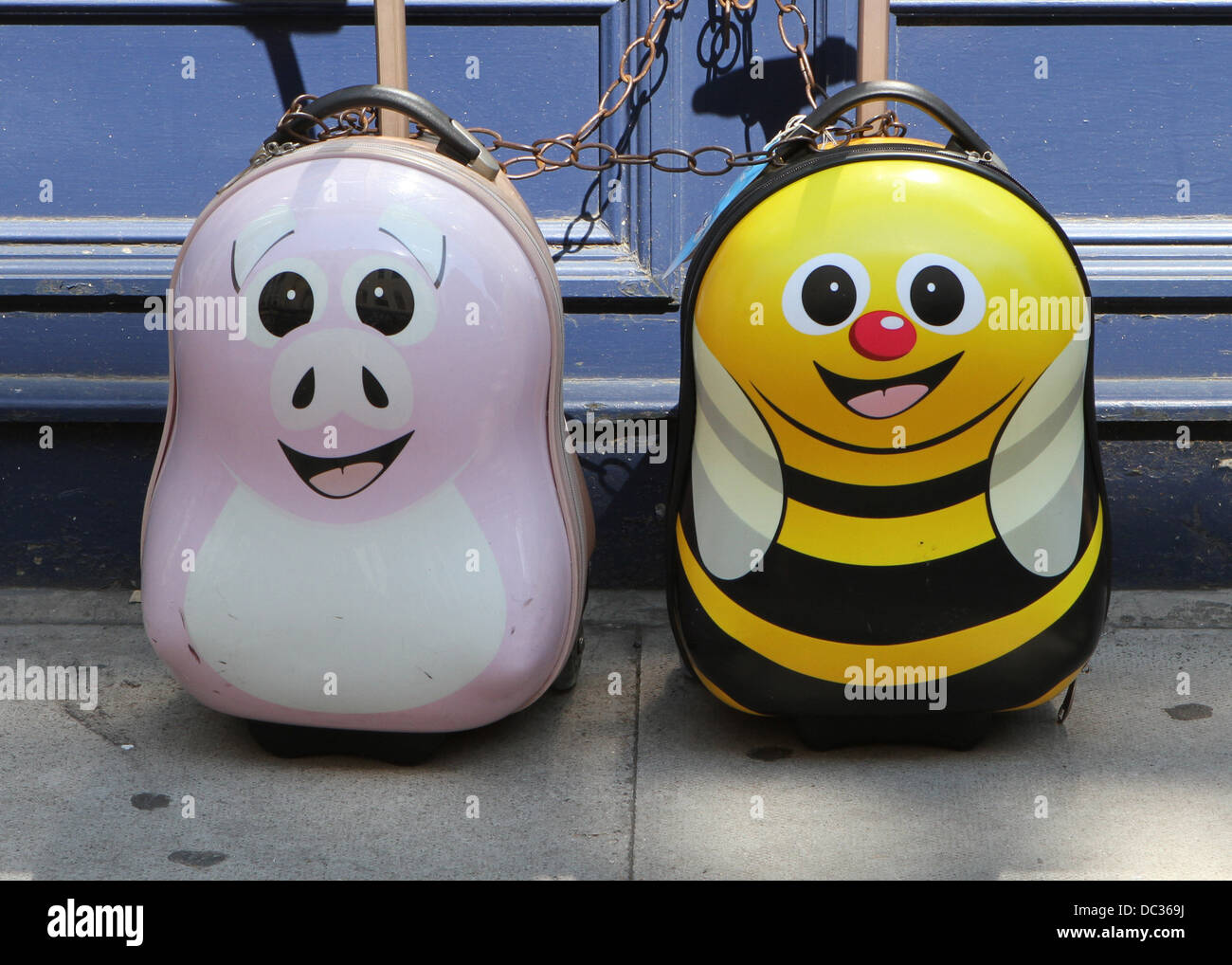 Two child's animal suitcases on display outside shop depicting a pig ...