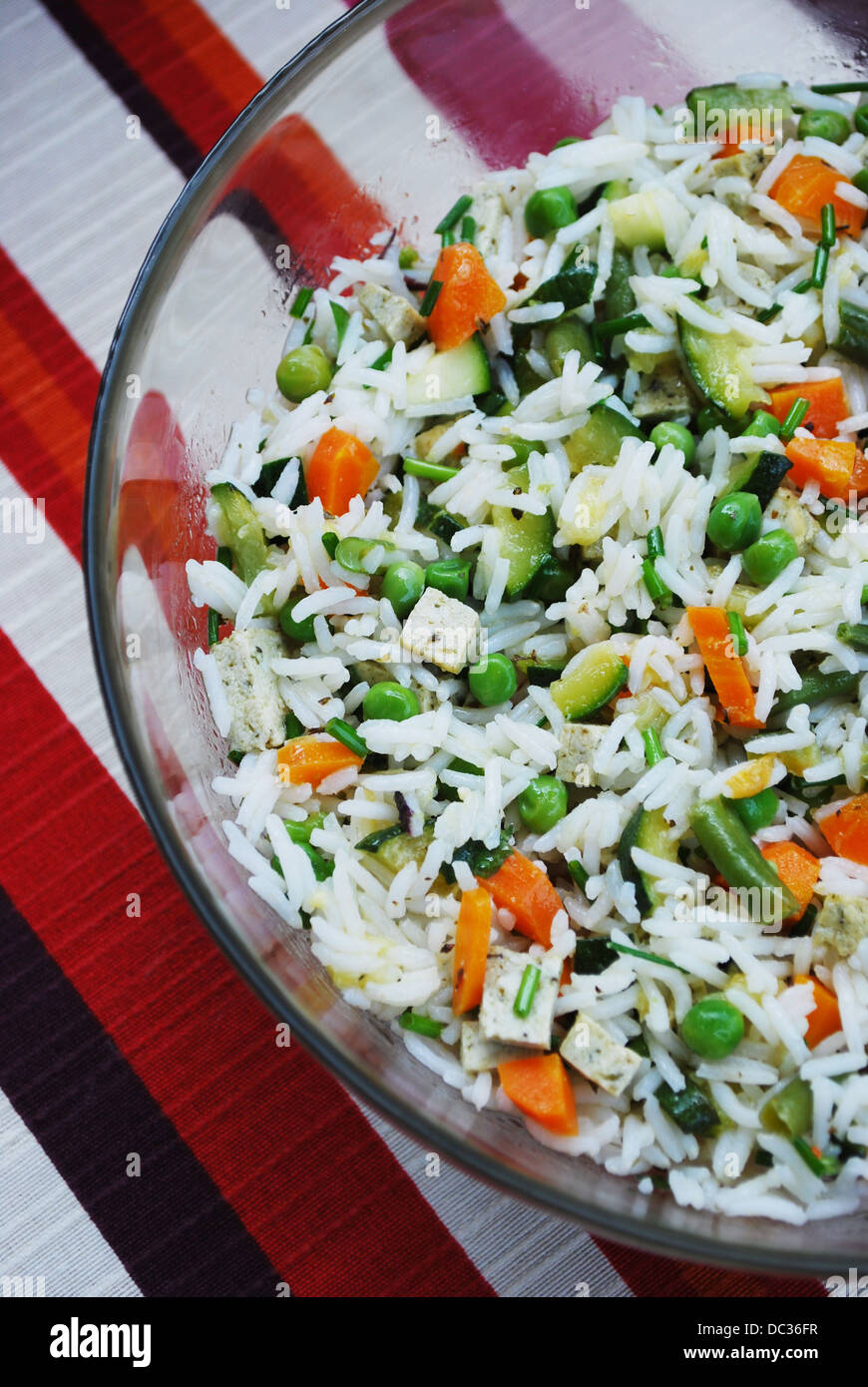 Vegetarian salad of white rice with mixed vegetables and tofu in a ...