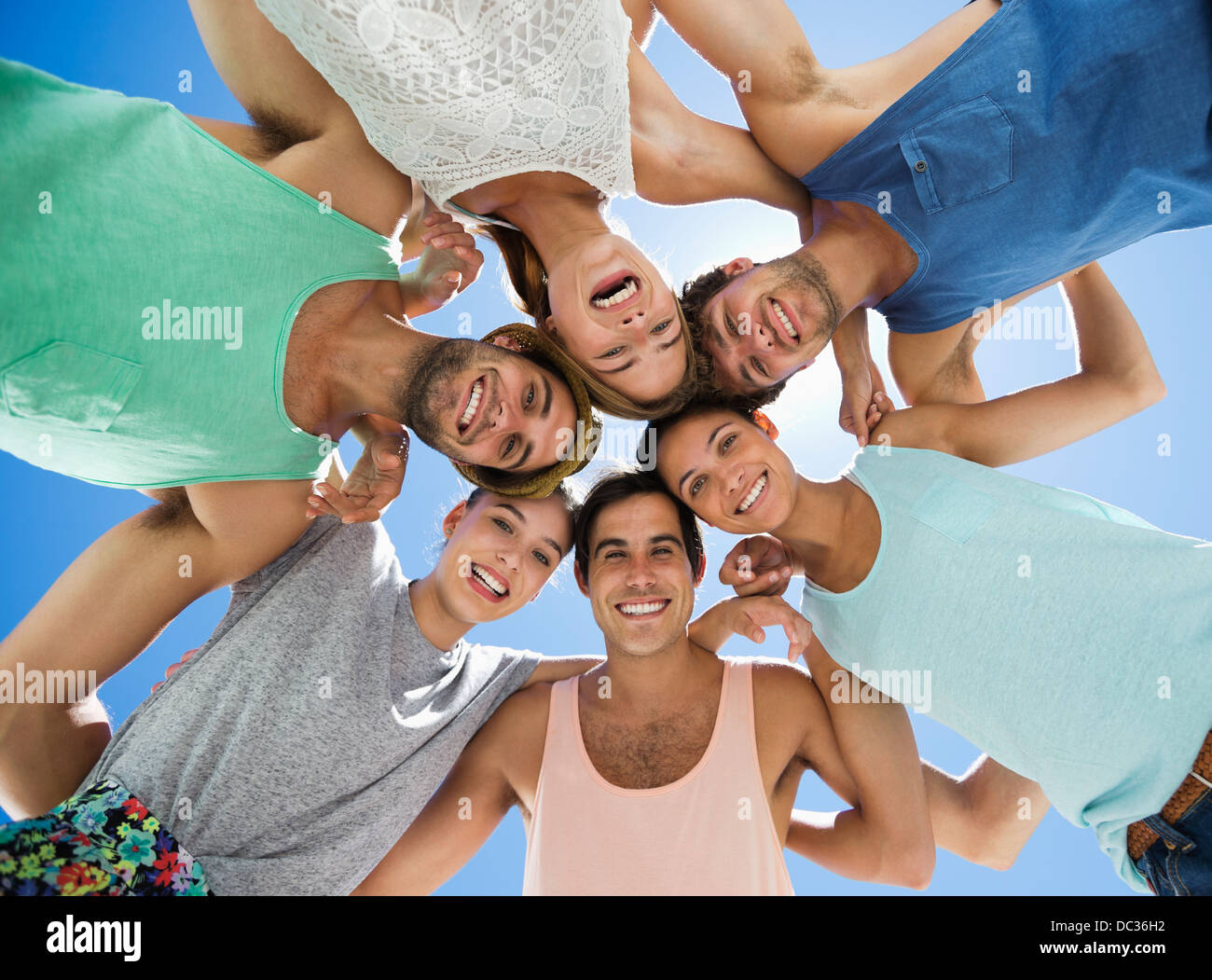 Low angle portrait of happy friends in huddle Stock Photo - Alamy