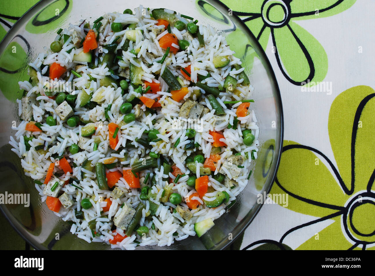 Vegetarian salad of white rice with mixed vegetables and tofu in a ...