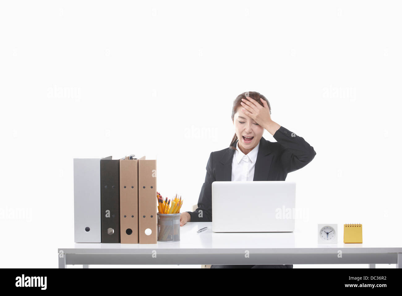 a businesswoman looking dull working with laptop at office desk Stock ...