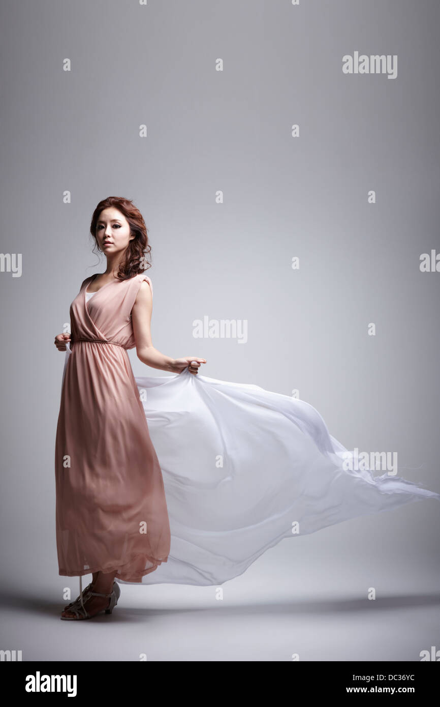 a lady in dress holding white cloth Stock Photo - Alamy