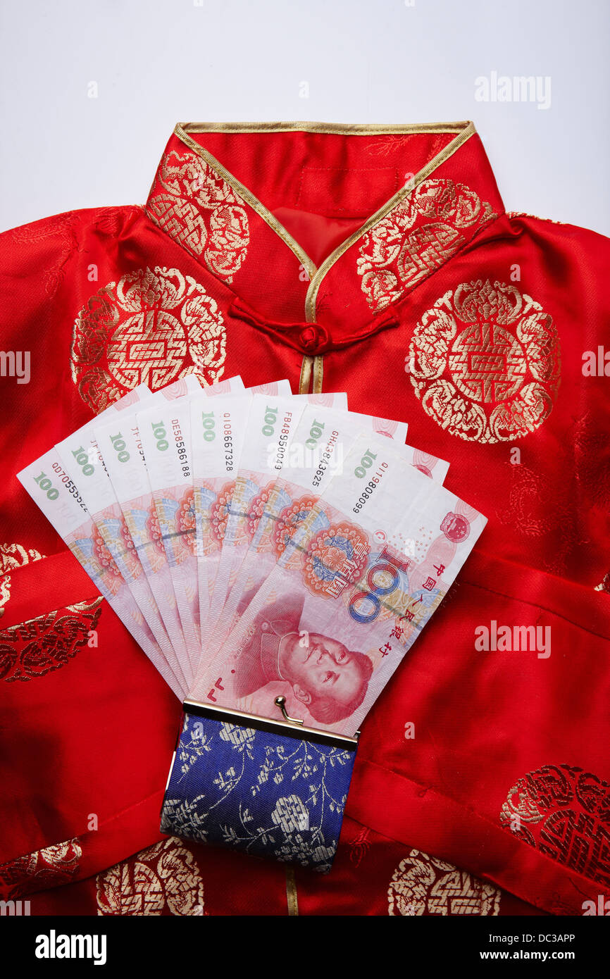 Chinese money on Chinese traditional costume Stock Photo - Alamy