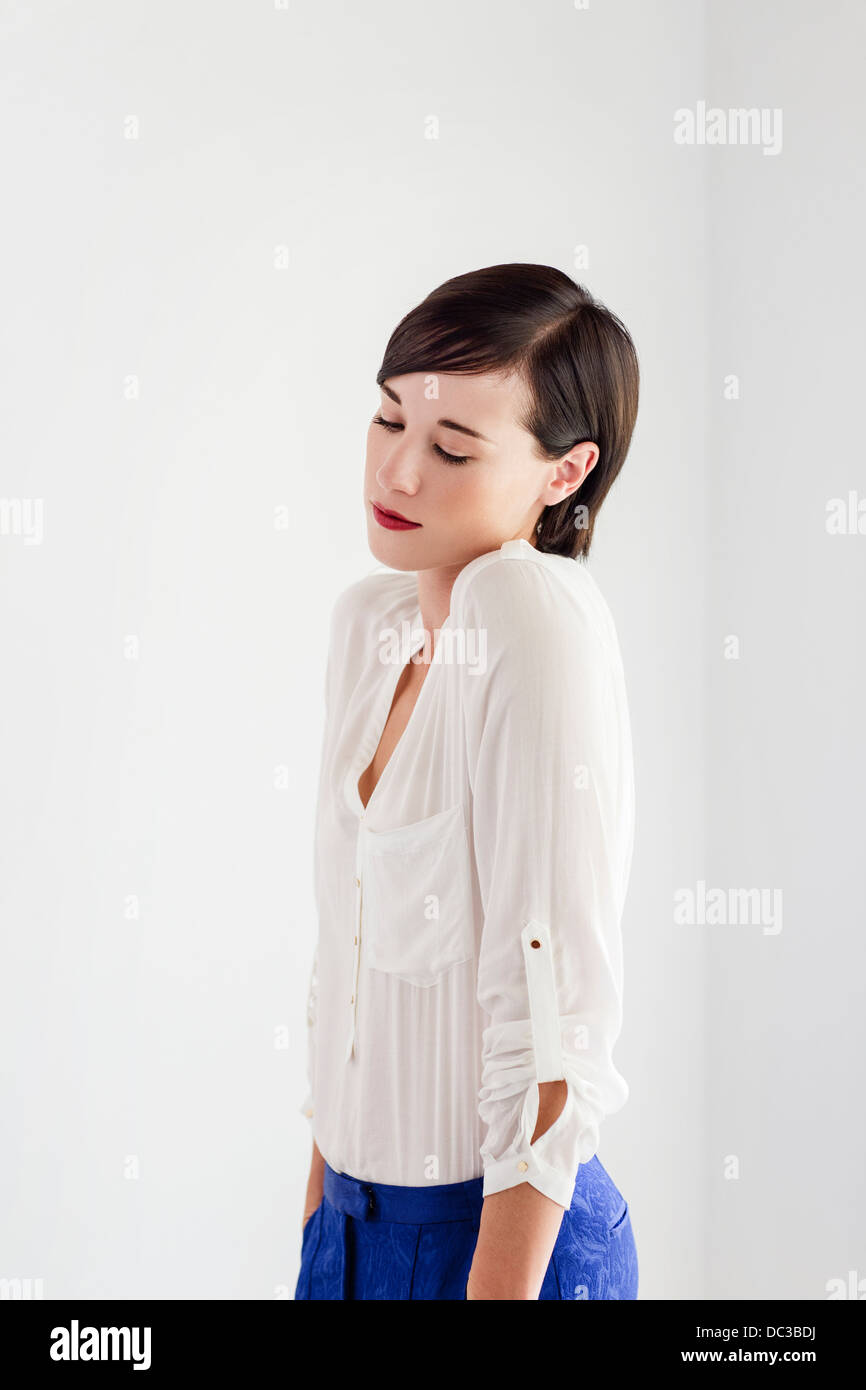 Serious woman shrugging and looking down Stock Photo - Alamy