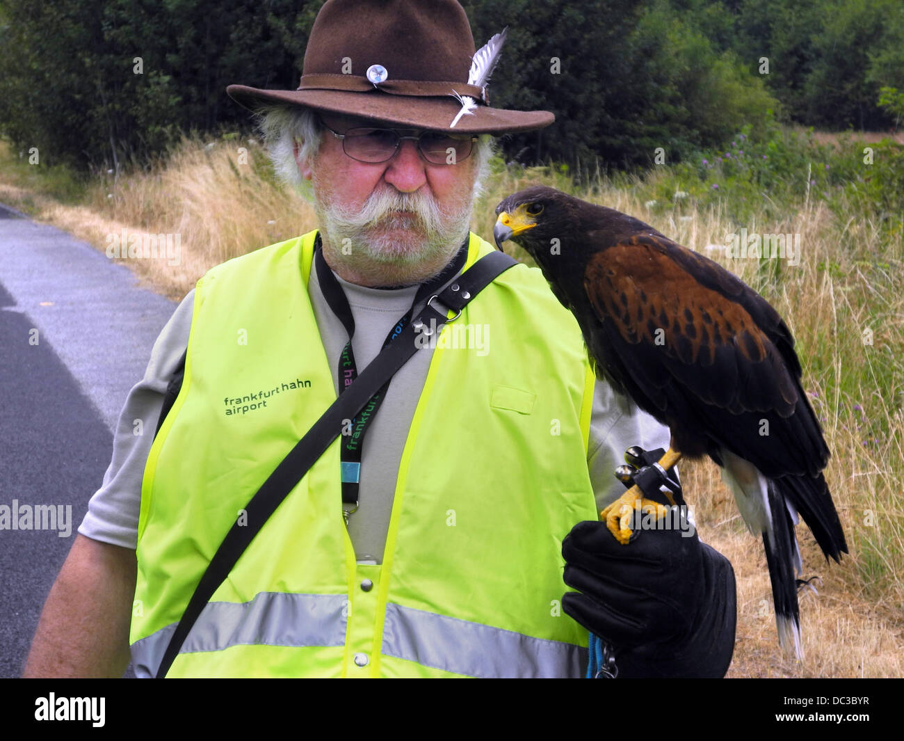 Falconer Walter Zell stands with his bird at the airport in Hahn ...