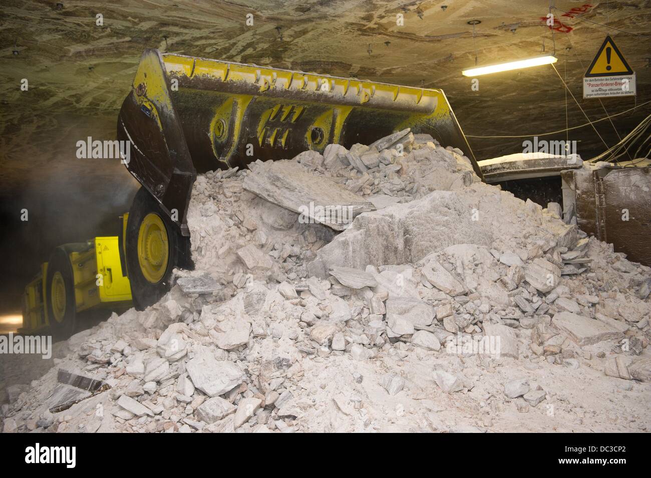 A tractor pushes newly exploded crude salt at the Werra Potash Plant ...