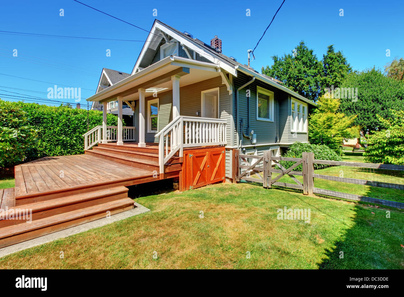 Small grey house with back porch and old fence Stock Photo - Alamy