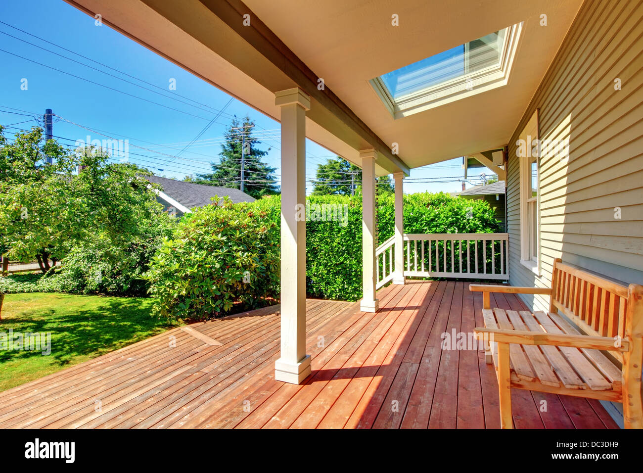 Large covered porch with skylight and wood bench and floor Stock Photo ...
