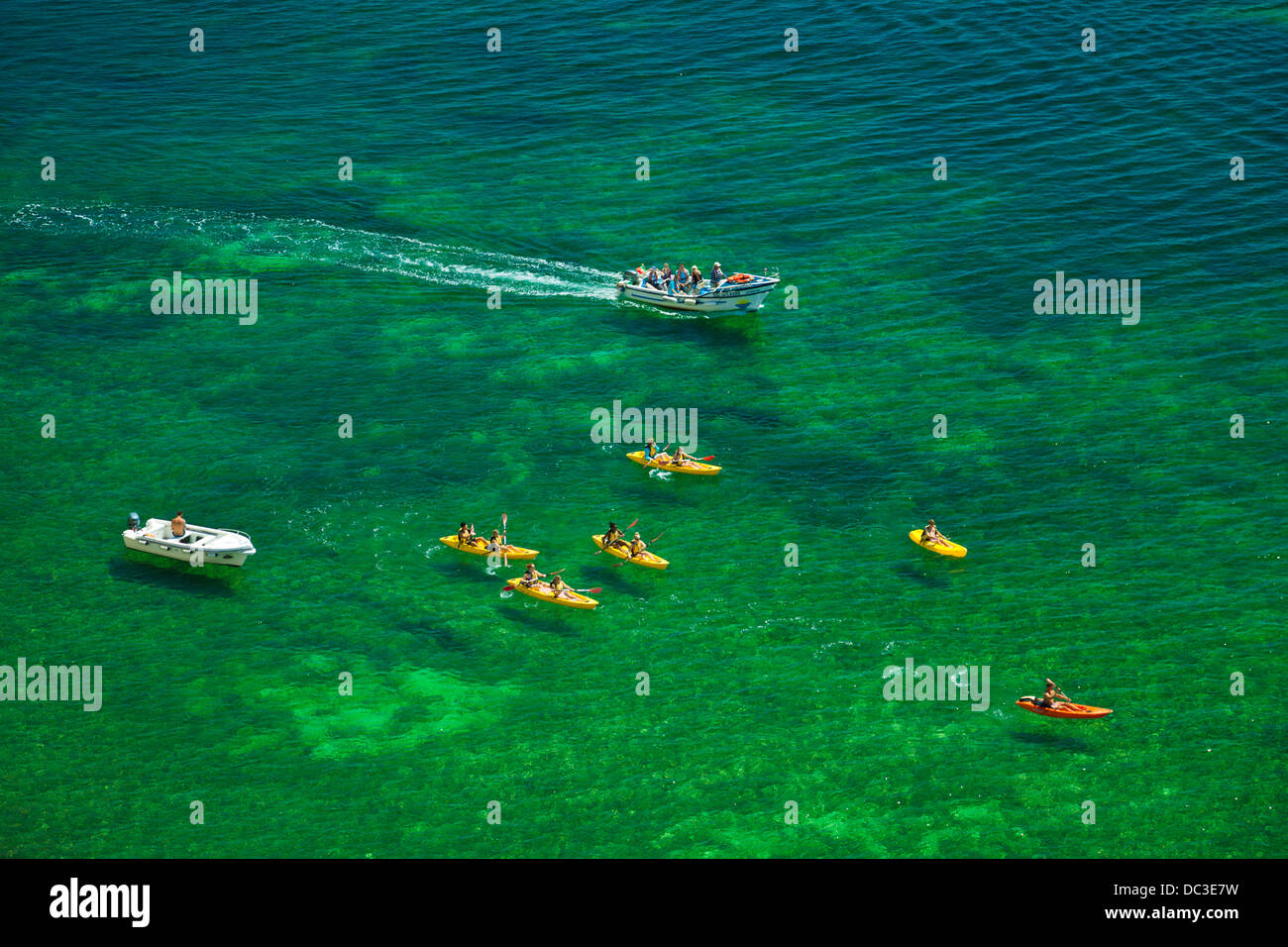 People in canoes and an excursion boat trip from Ponta da Piedade Lagos ...