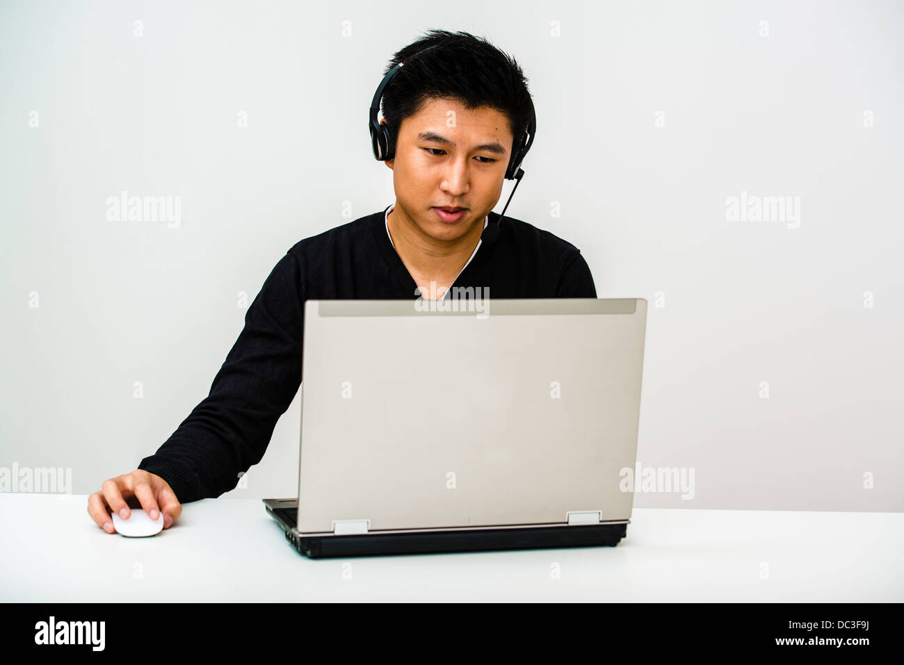 Asian Customer Service Helpdesk Operator Talking To A Customer And ...