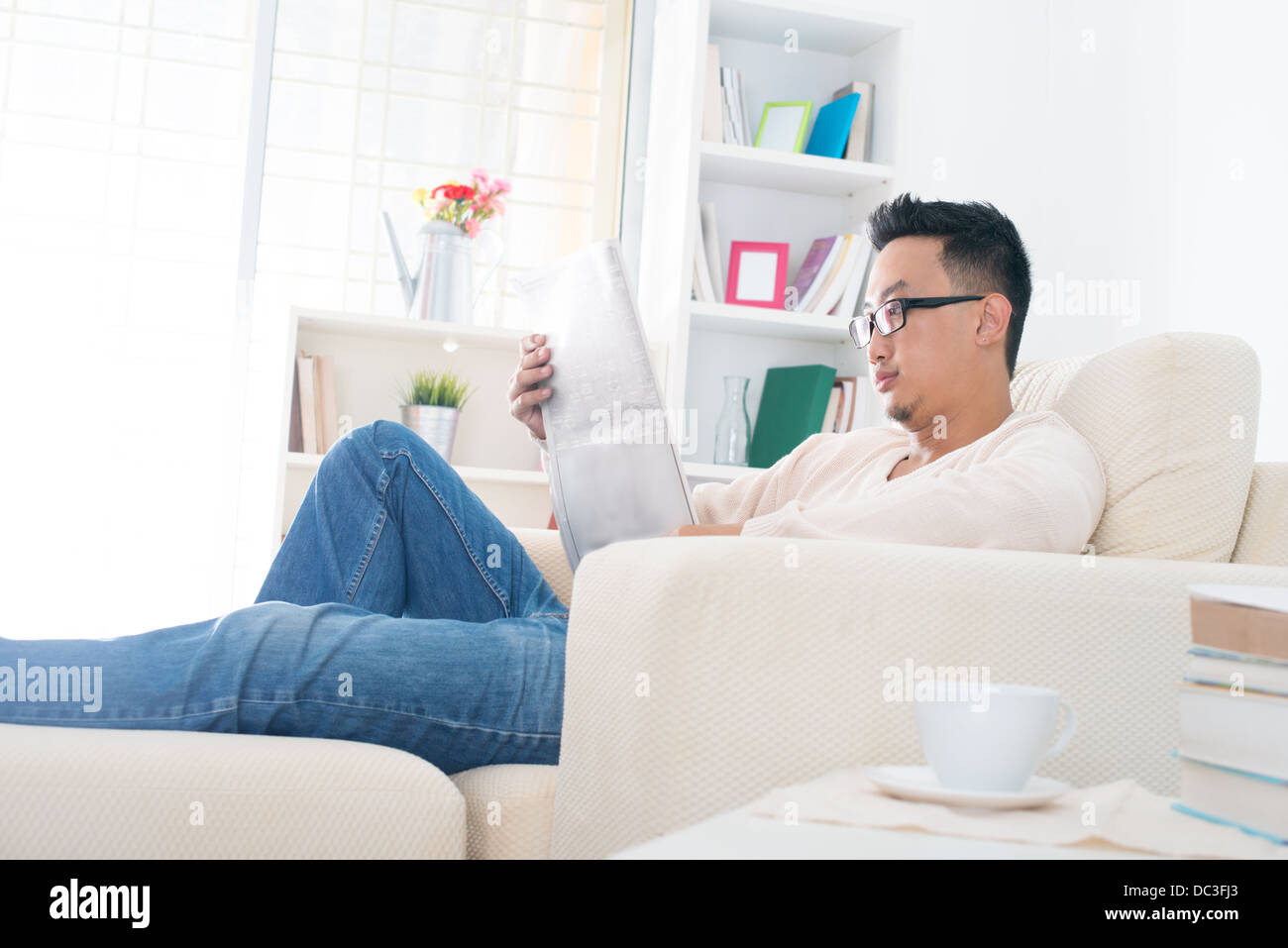 Asian man reading news paper Stock Photo - Alamy
