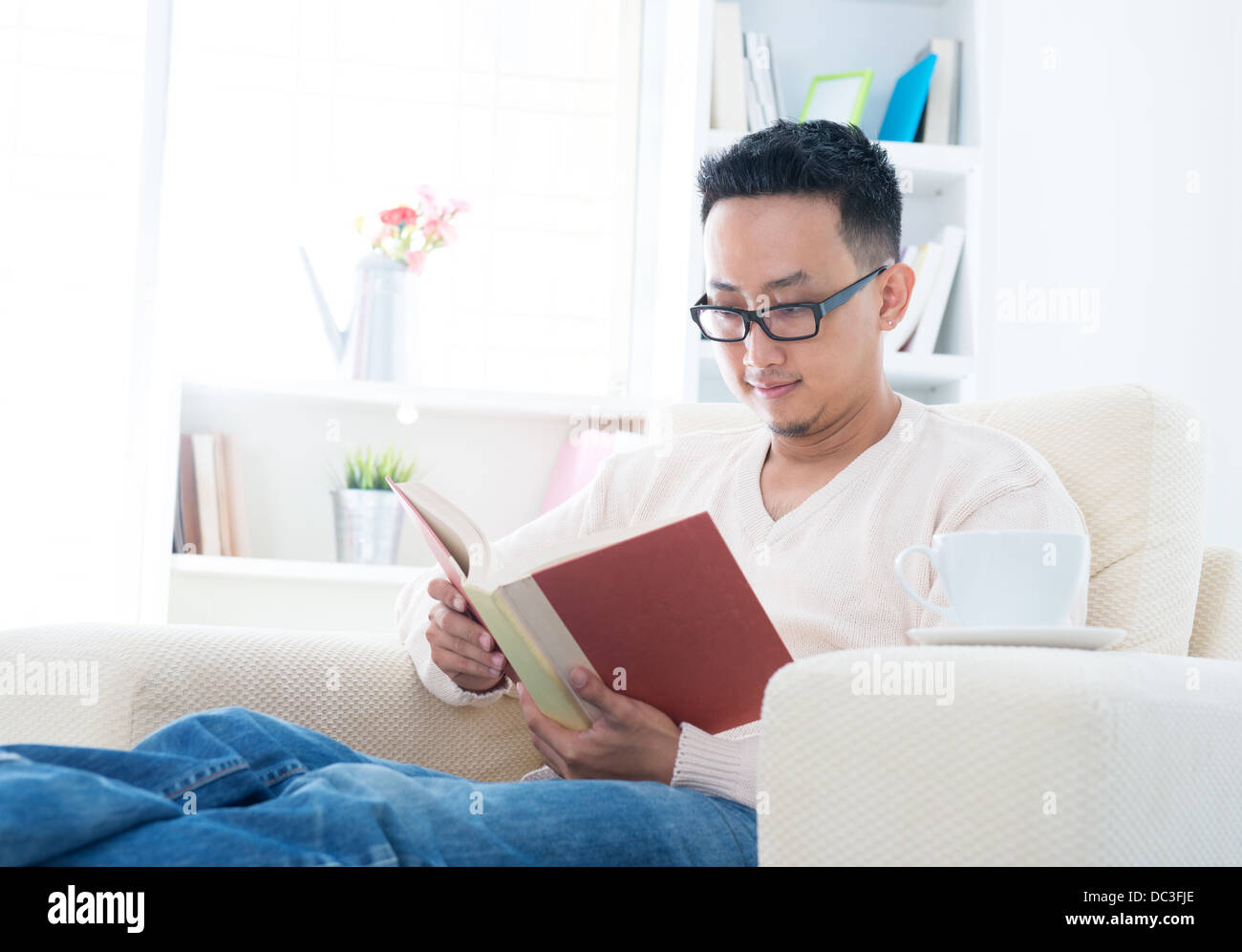 Southeast Asian male reading book Stock Photo - Alamy
