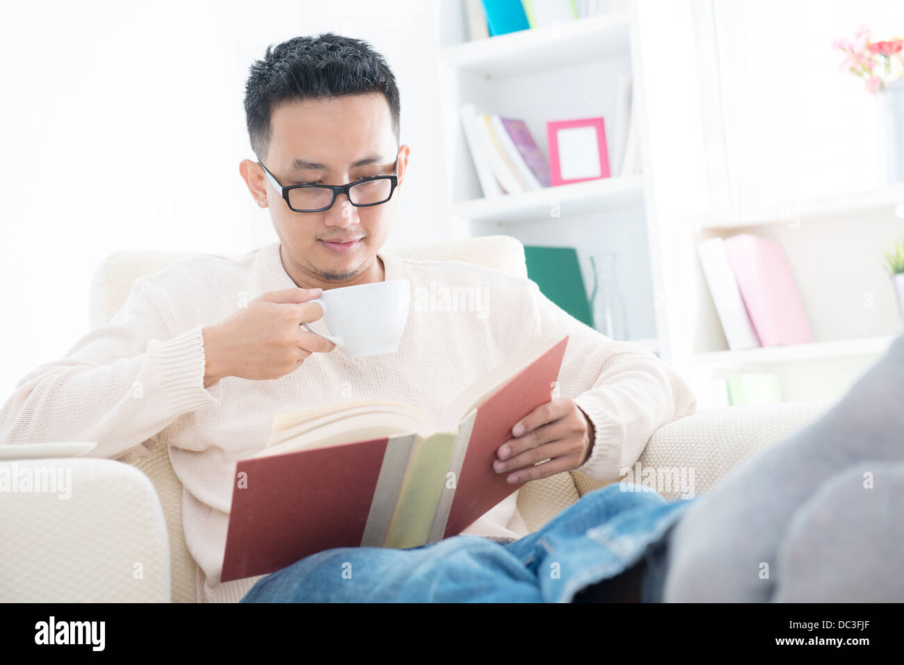 Southeast Asian male reading a book Stock Photo - Alamy