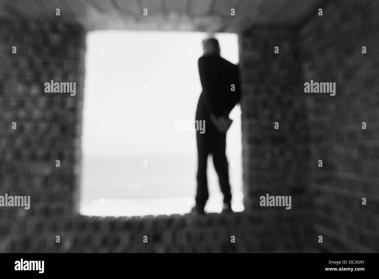 Man standing back window Black and White Stock Photos & Images - Alamy