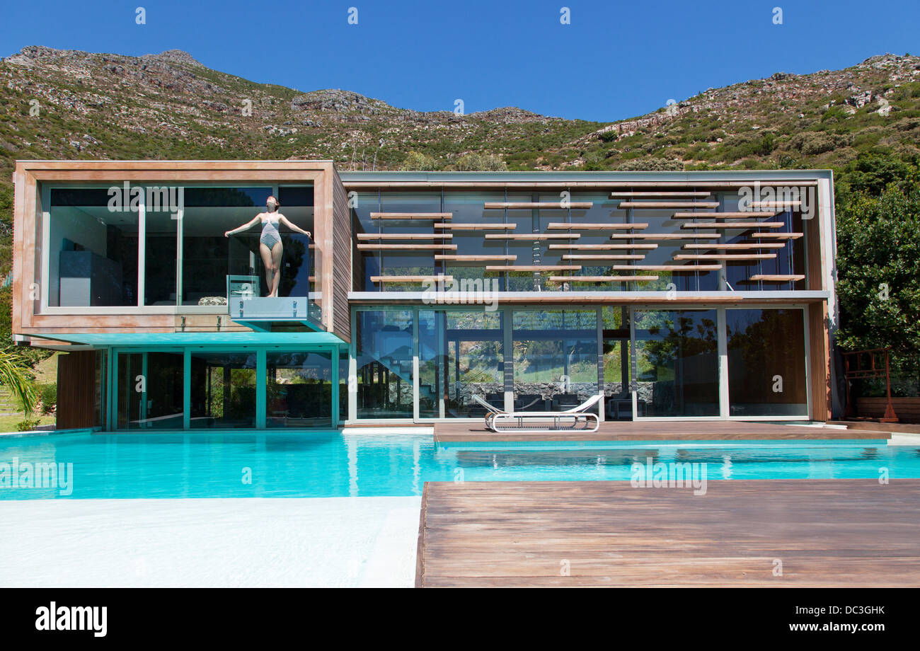 Woman on balcony over swimming pool Stock Photo - Alamy