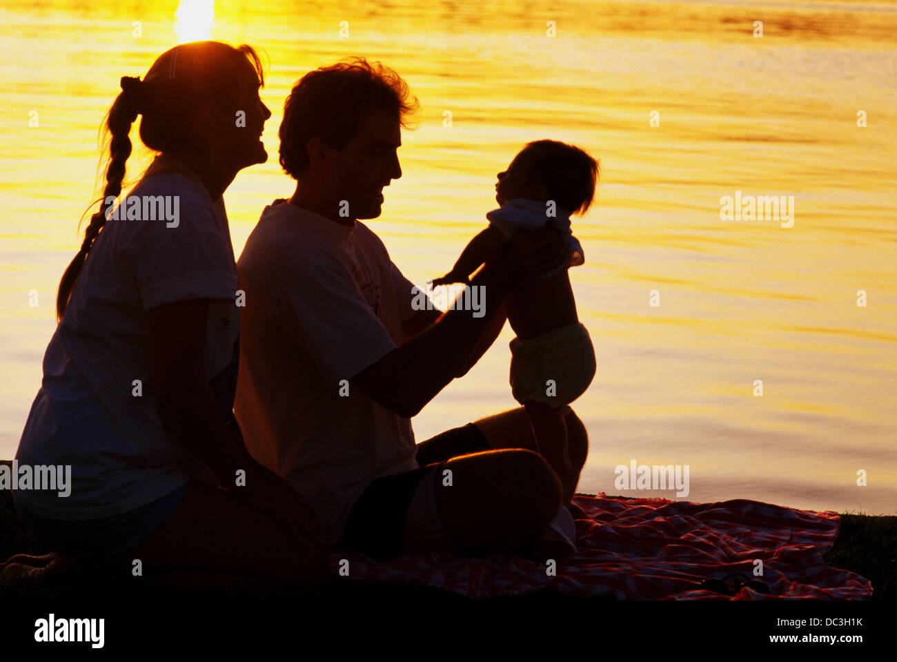 Family together at sunset Stock Photo - Alamy