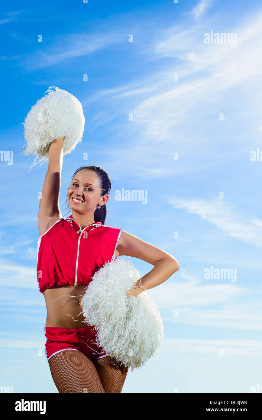 Young cheerleader in red costume with pampon Stock Photo - Alamy
